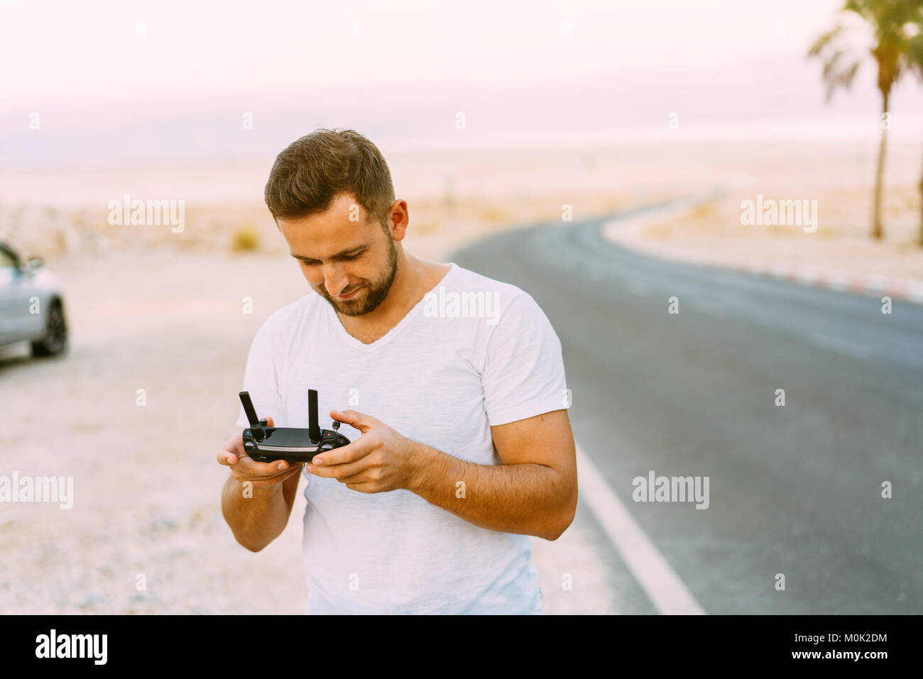 Guy controls drone with remote control Stock Photo - Alamy