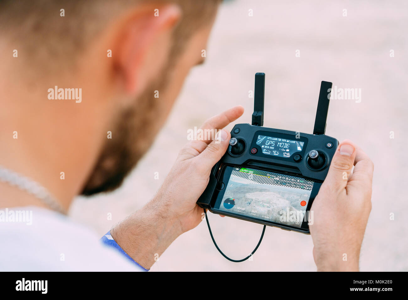 Guy controls drone with remote control Stock Photo - Alamy