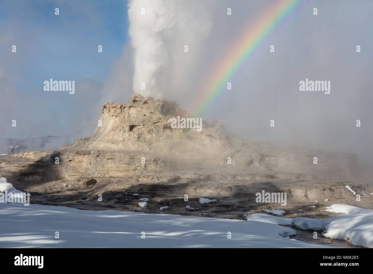 A rainbow forms as the Castle Geyser erupts in the Upper Geyser Basin ...