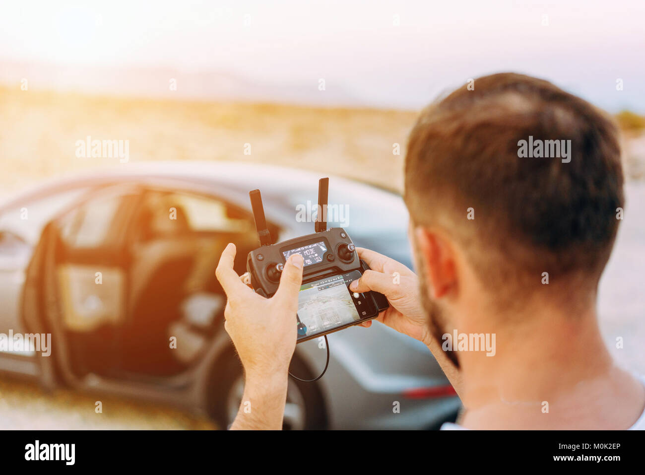Guy controls drone with remote control Stock Photo - Alamy