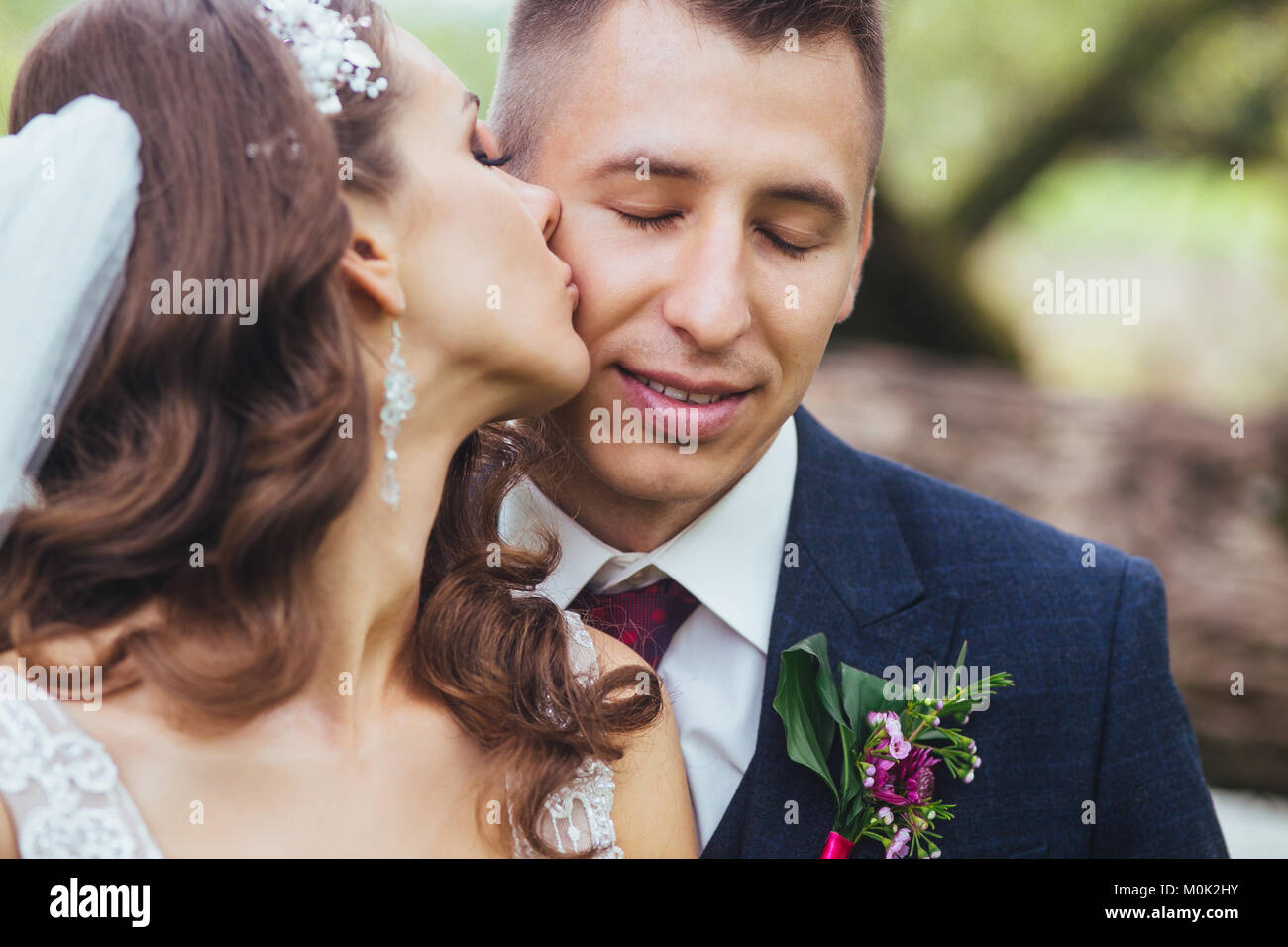 Beautiful newlywed bride and groom hugging in park. face close-up Stock ...