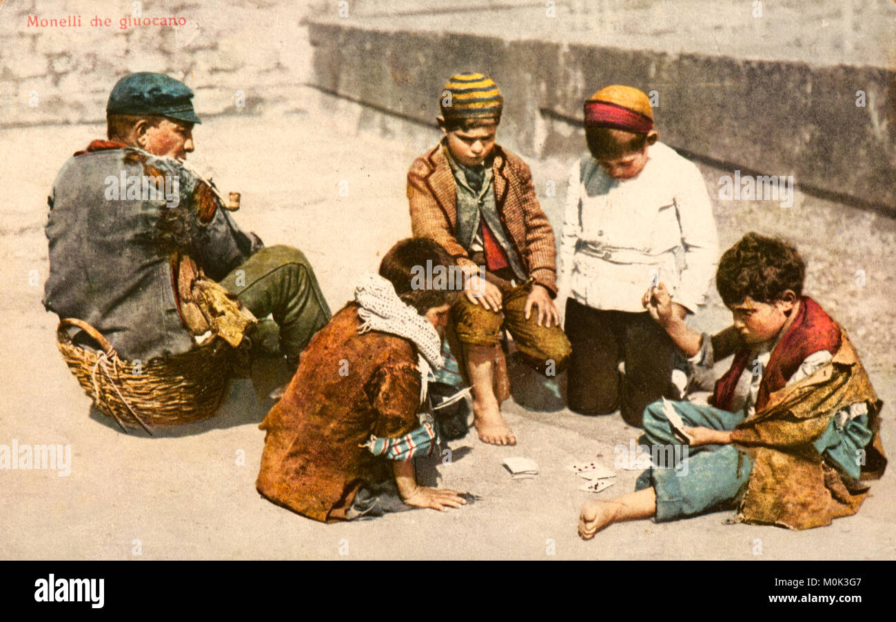 Group of poor kids playing cards in the streets on an italian city ...