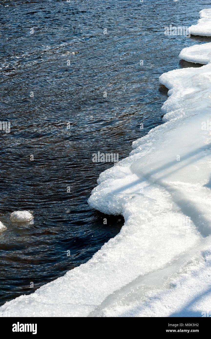 edge of the ice by flowing water Stock Photo - Alamy