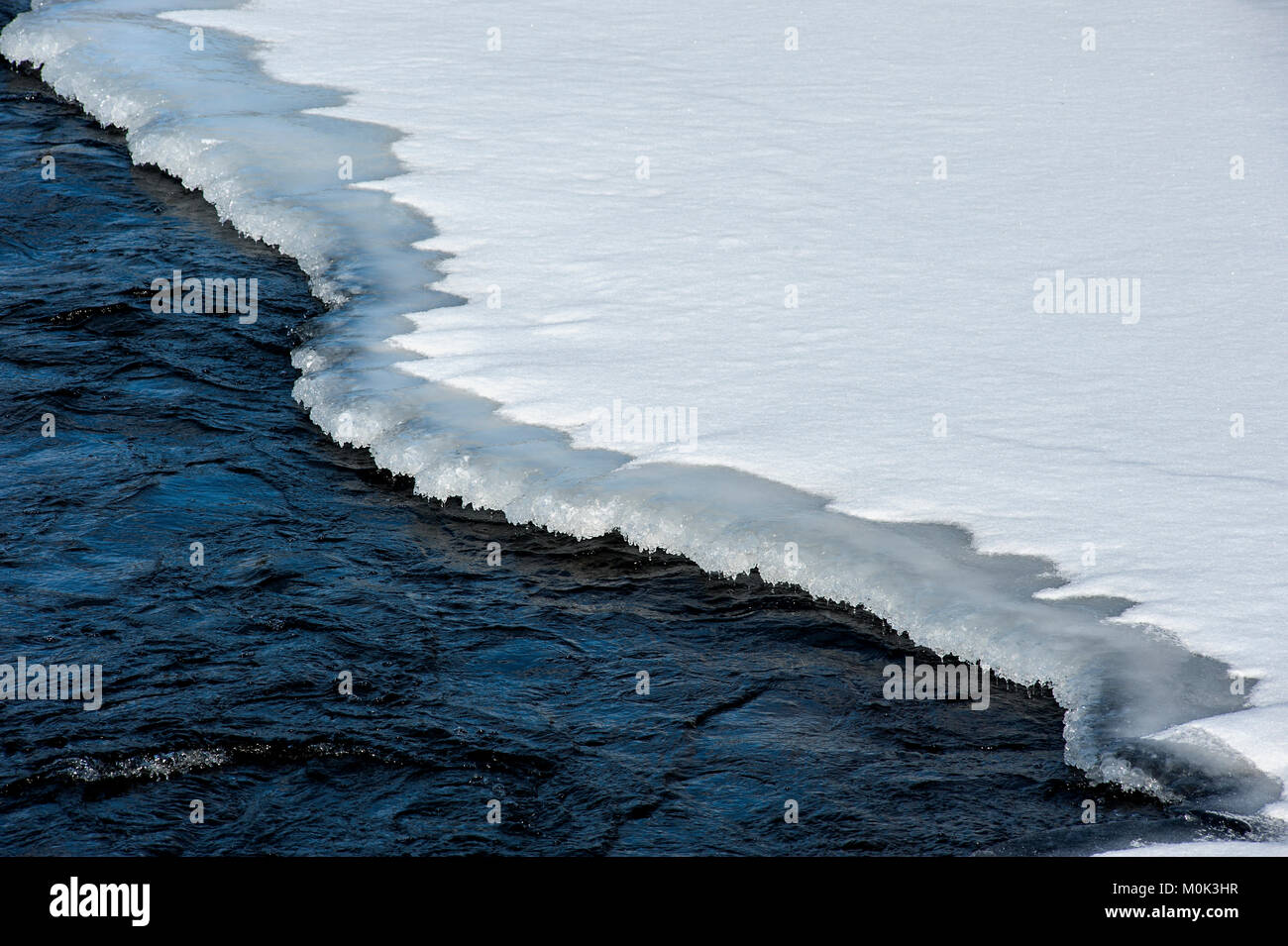 edge of the ice by flowing water Stock Photo - Alamy