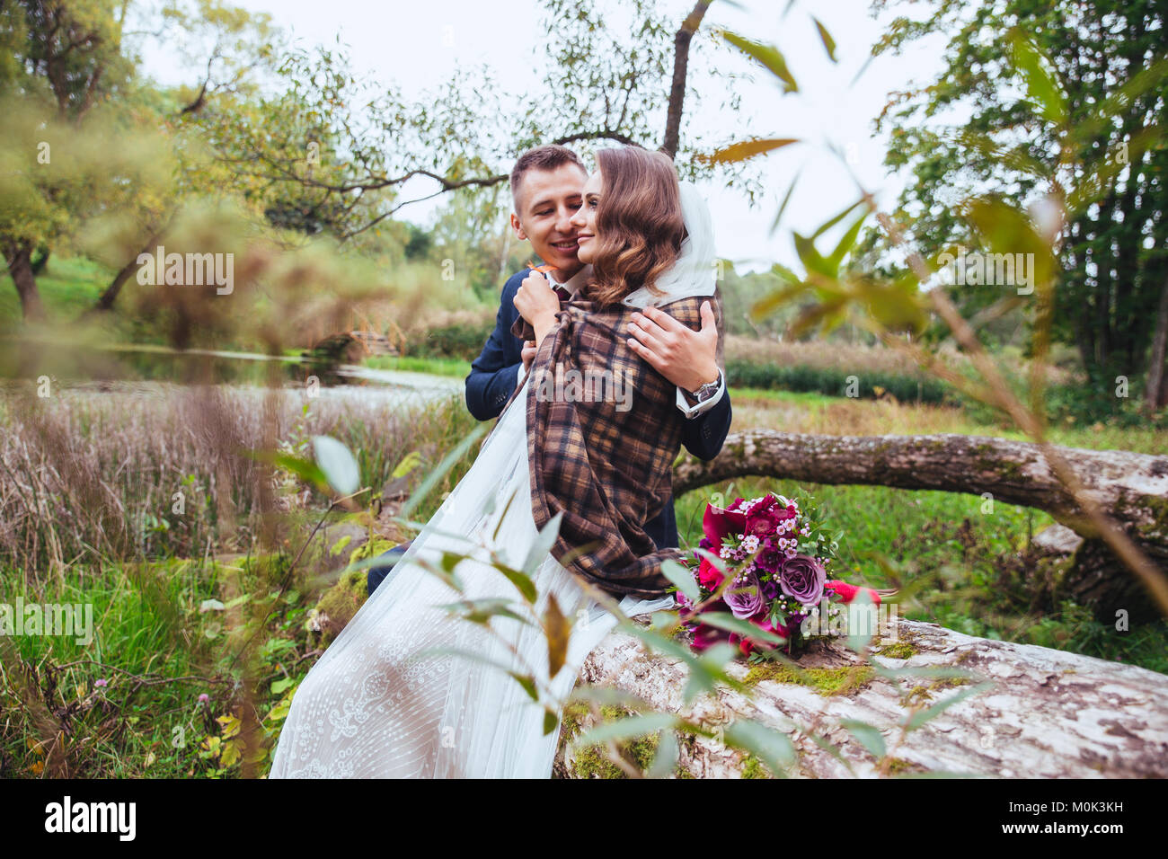 Just married couple under a beautiful tree Stock Photo - Alamy