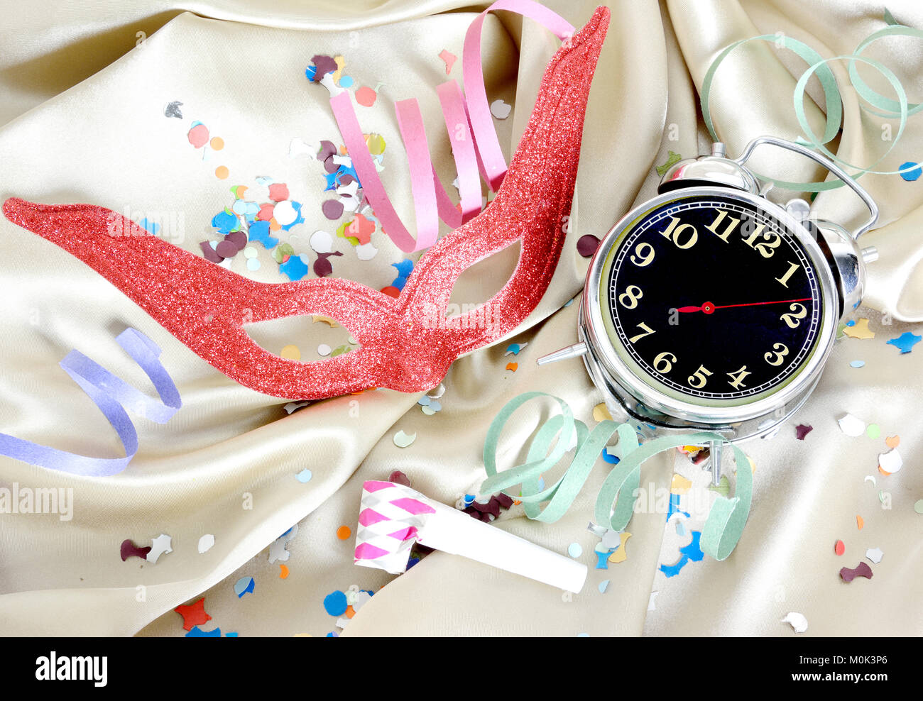 Carnival concept with an alarm clock, mask , confetti, serpentines on ...