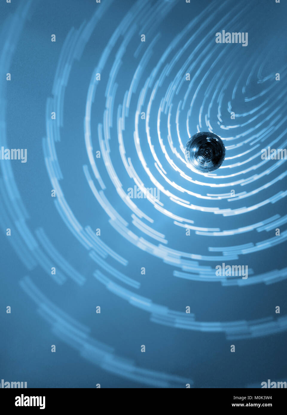 Disk ball in motion on blue background Stock Photo - Alamy