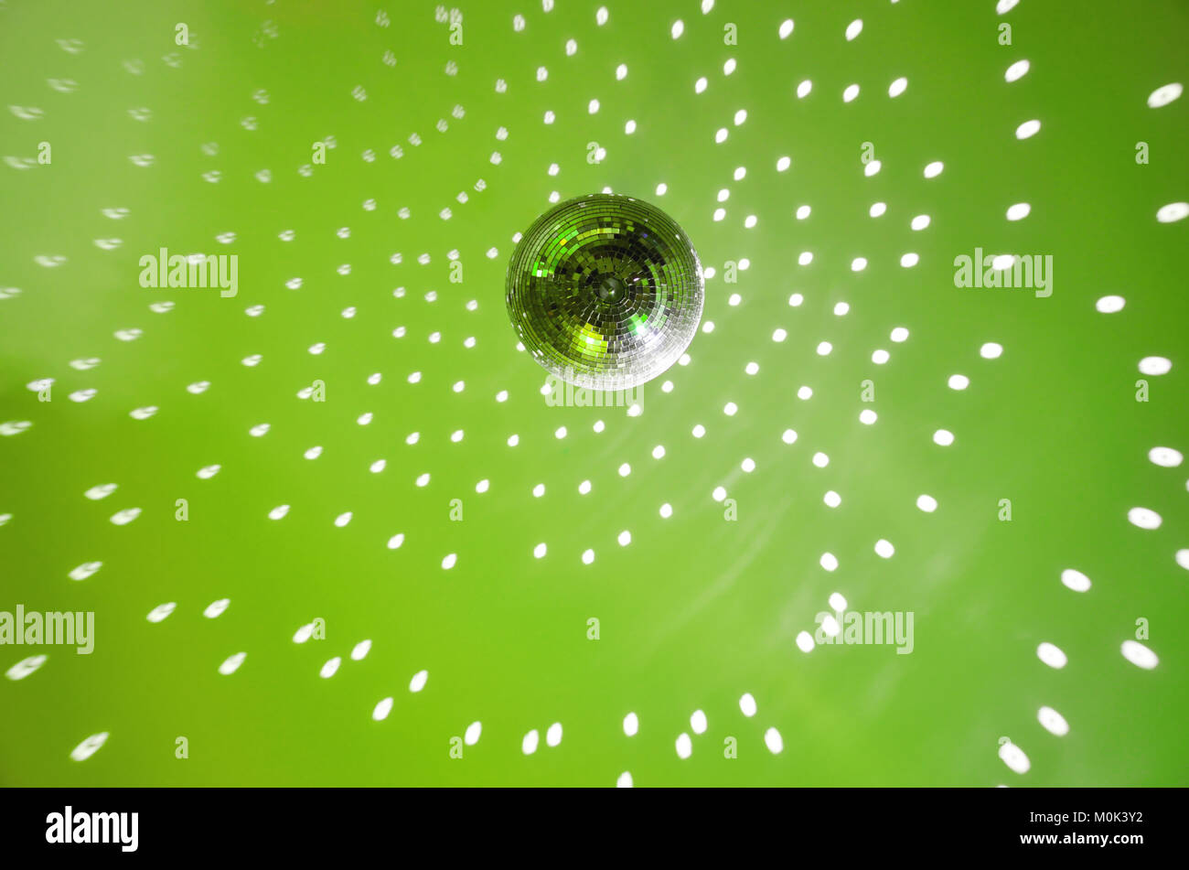 Disk ball in motion on green background Stock Photo - Alamy