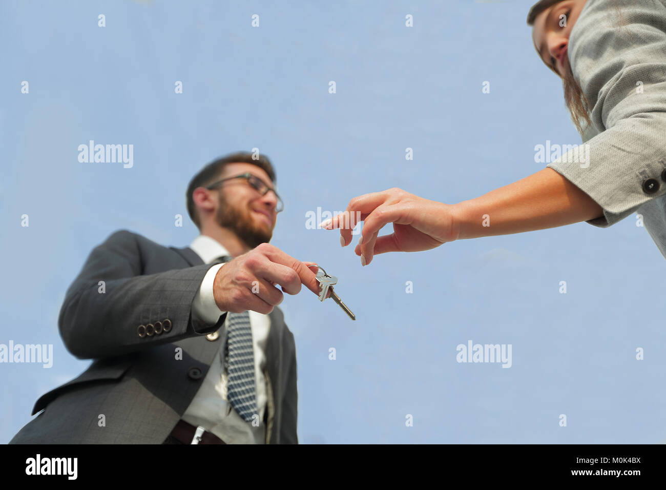 Cropped image of estate agent giving house keys to man in office Stock ...