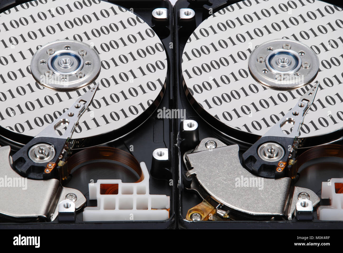 Binary code on two HDD Stock Photo - Alamy