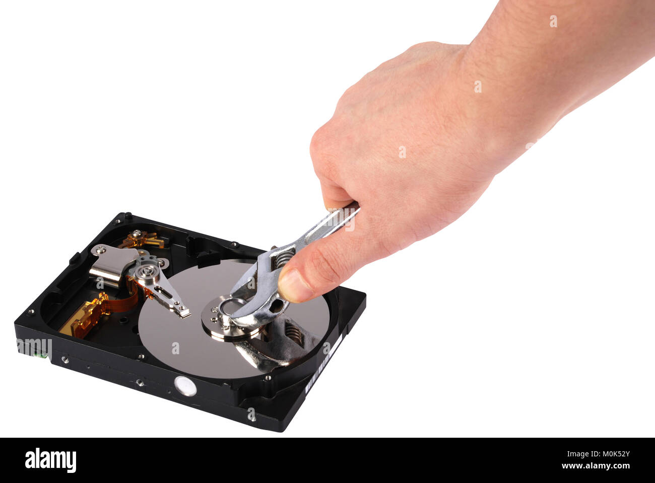 The hand with adjustable wrench turn off a hard disk. On a white ...