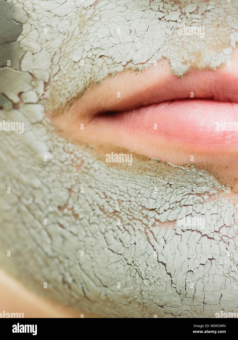 Skin care. Woman in clay mud mask on face isolated on white. Girl ...