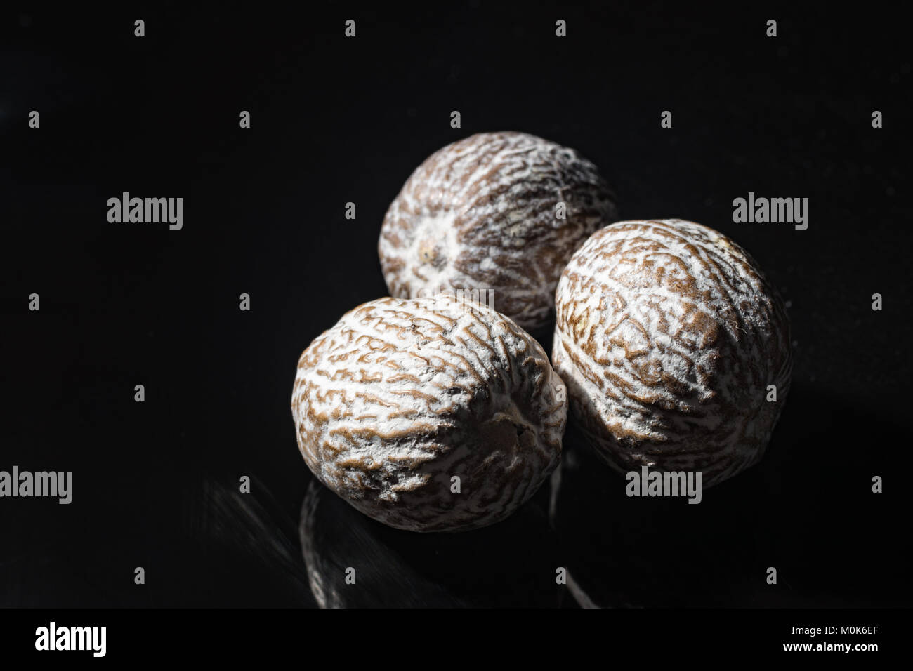 Macro collection, dried muscat nutmeg close up on black background copy ...