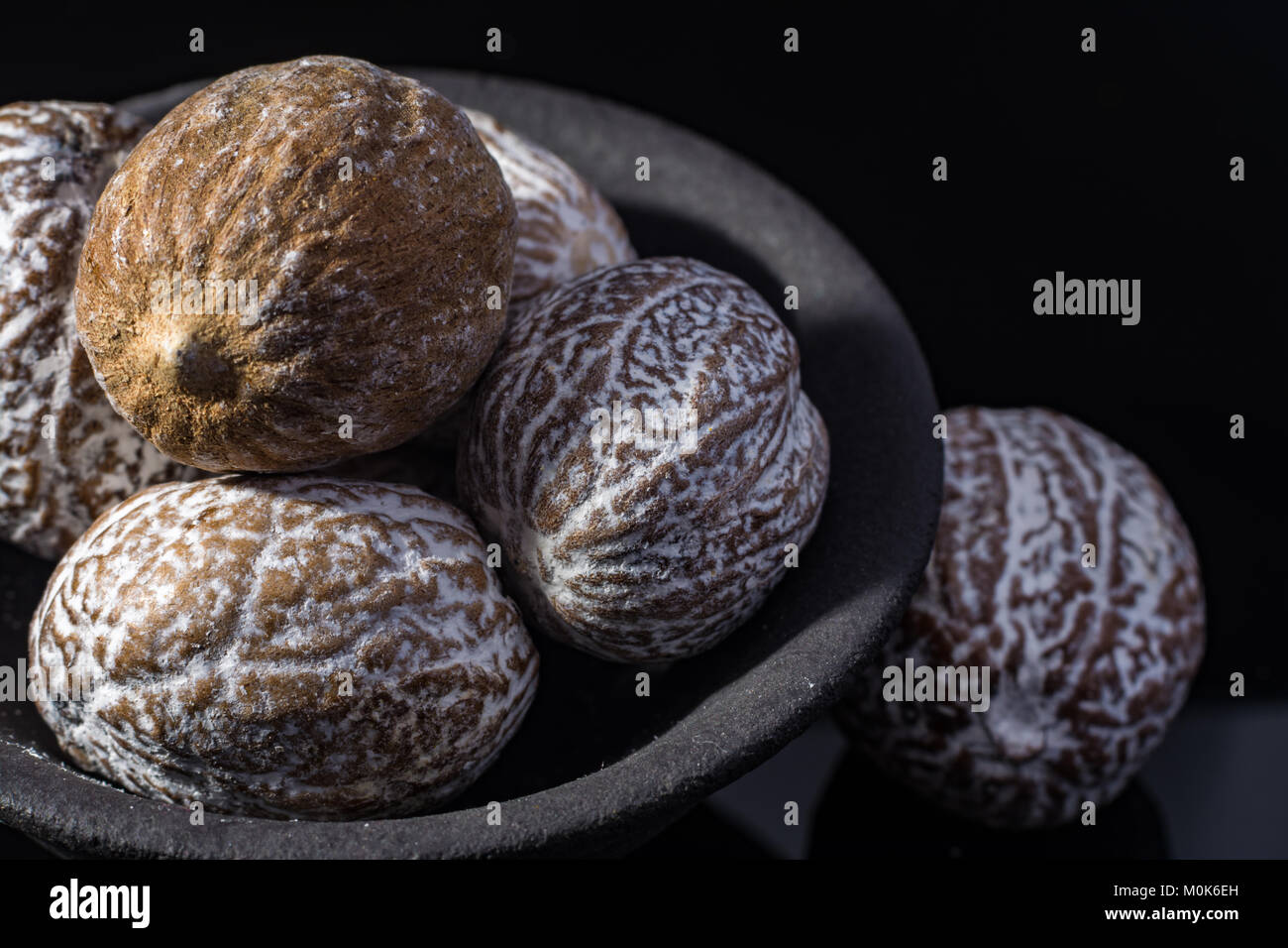 Macro collection, dried muscat nutmeg close up on black background ...