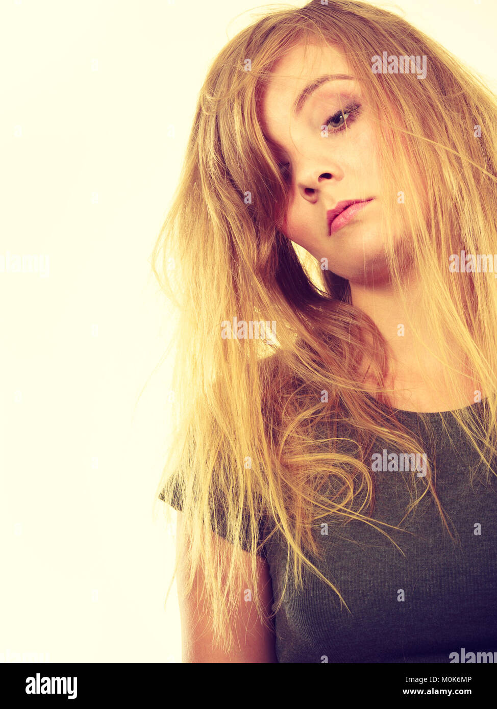 Bad hairstyle concept. Sad blonde woman with messy hair looking tired ...