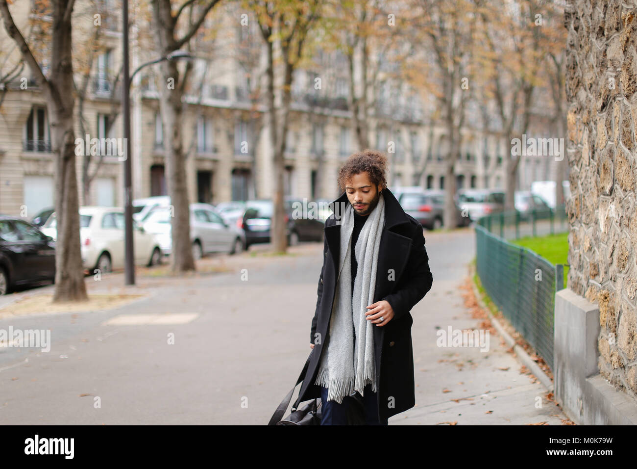 Sad mix blood man going to railway station and looking at watch Stock ...