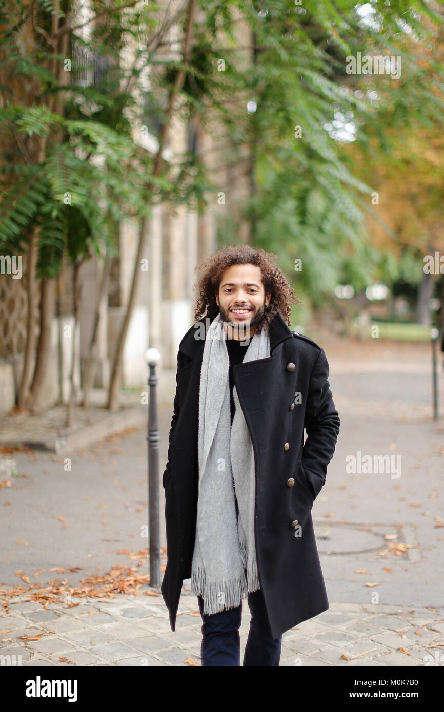 Jocund mulatto guy shaking head with fleecy hair and laughing Stock ...