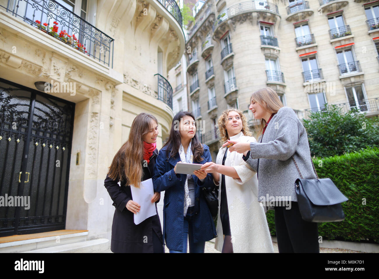 Happy female students talking outside in near university build Stock ...