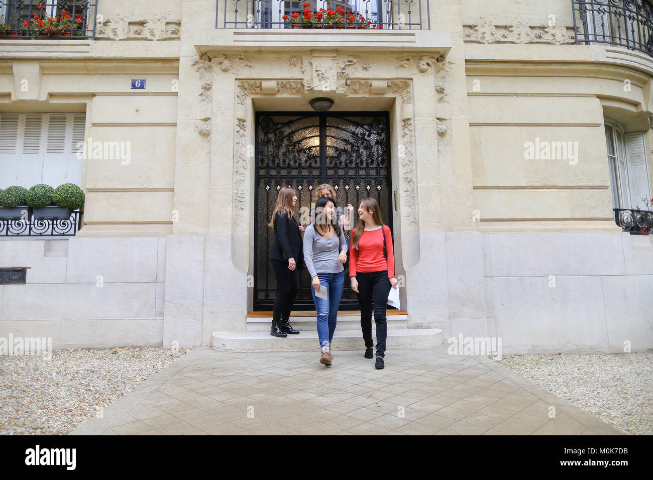 Happy students leaving university building in Stock Photo - Alamy