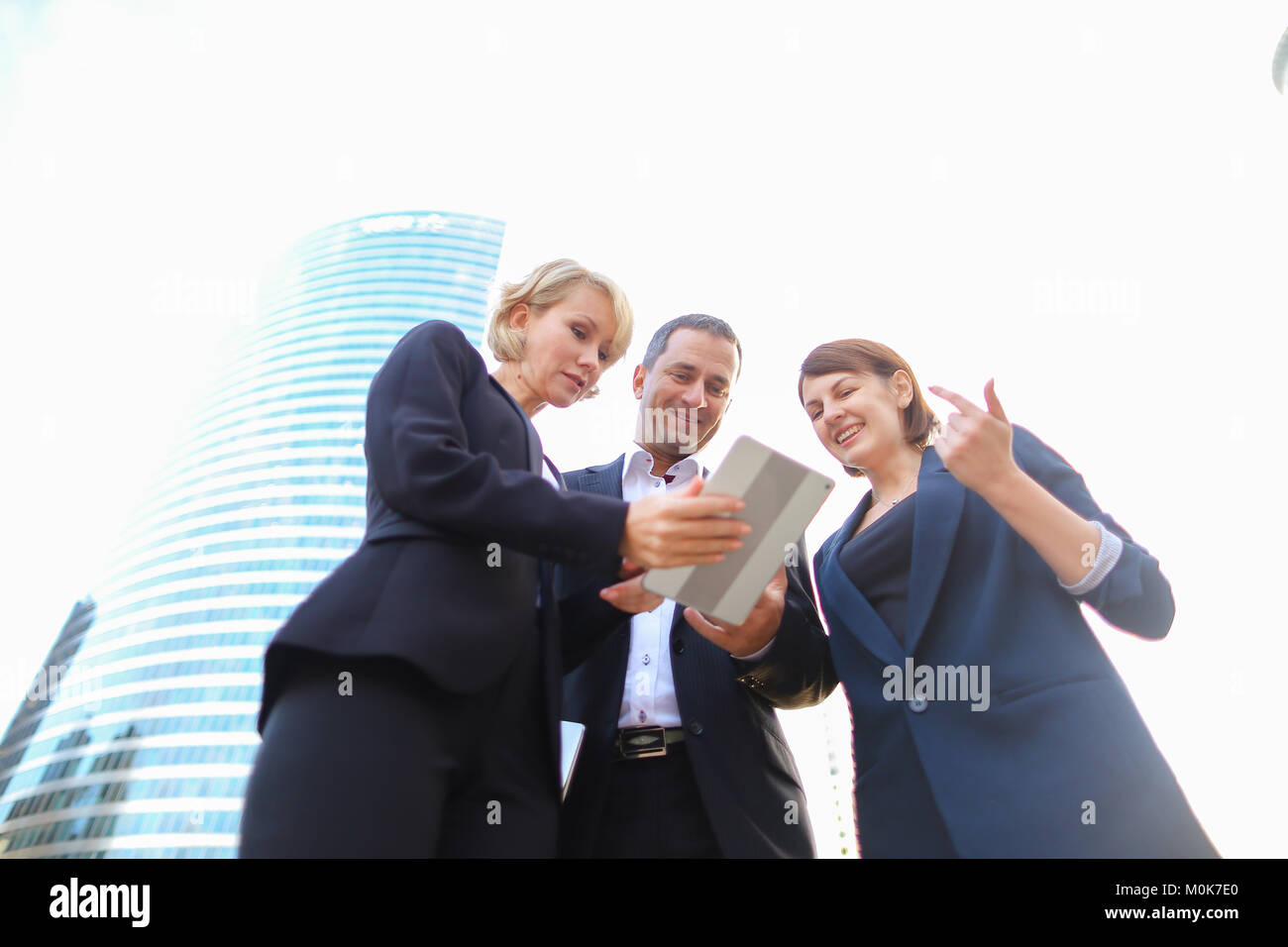 Happy business team members talking outside in Stock Photo - Alamy