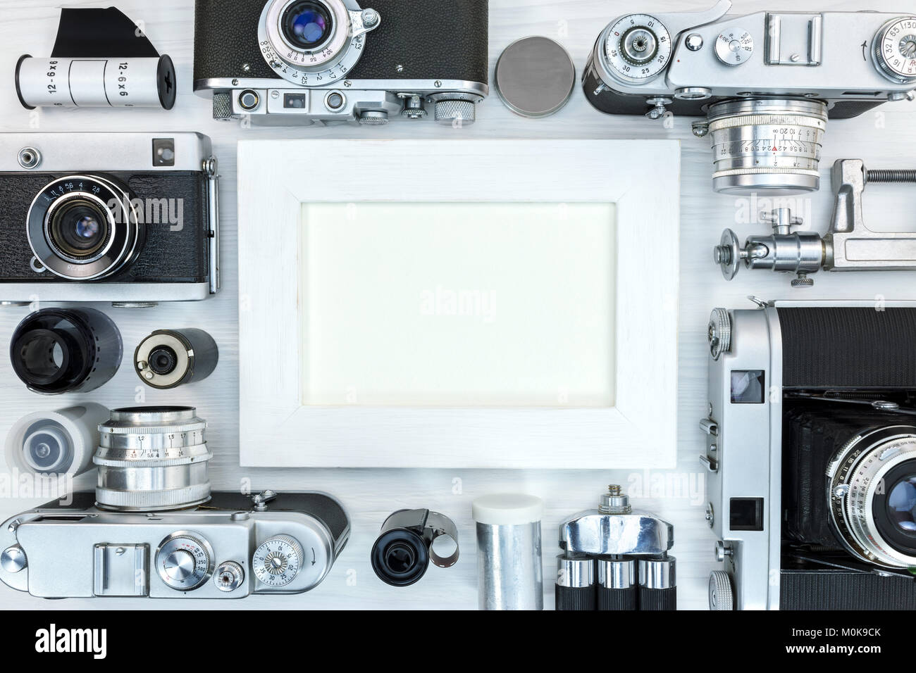 empty photo frame with old classic cameras, equipment and accessories ...