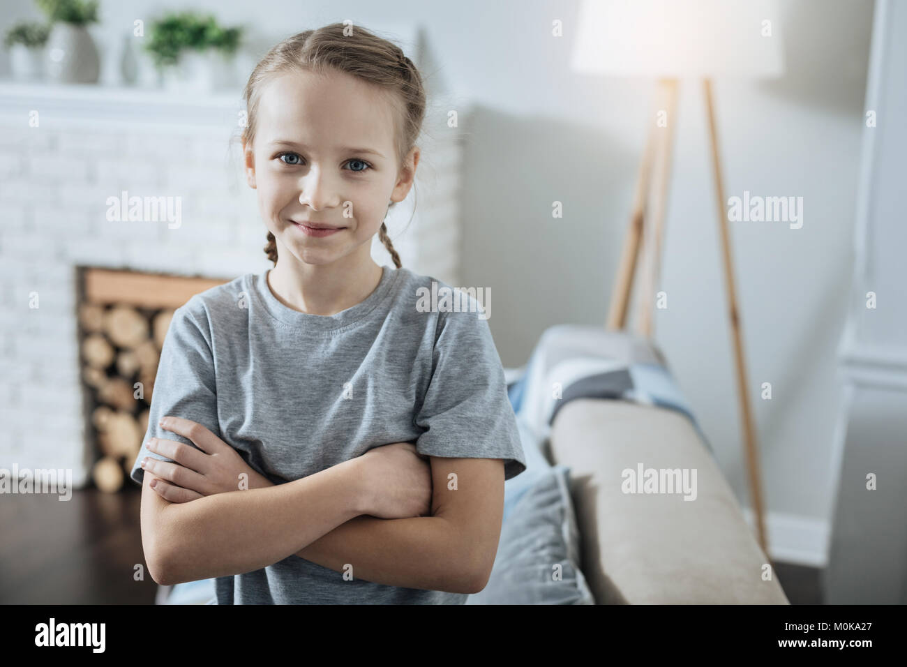 Content girl standing with her hands crossed Stock Photo - Alamy