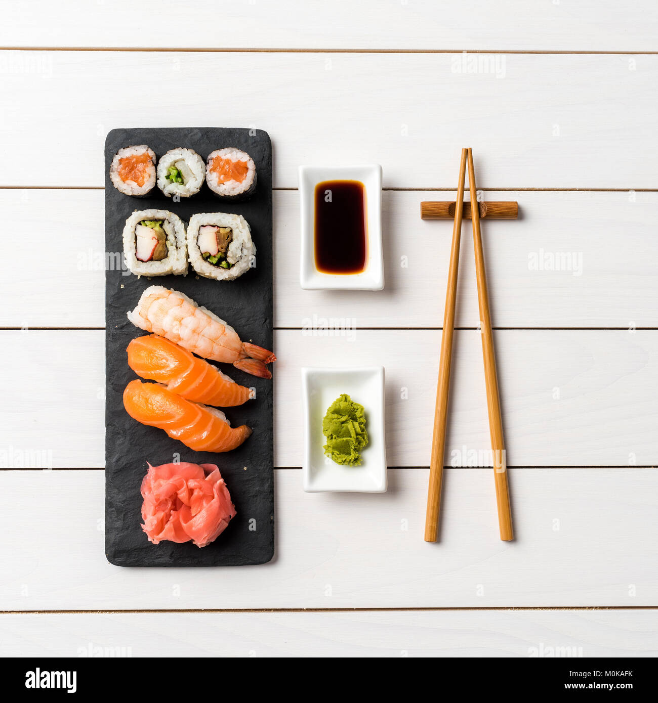 Set of Japanese sushi on white wooden table Stock Photo - Alamy