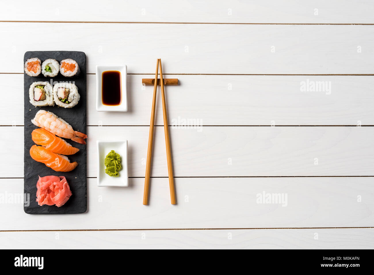Set of Japanese sushi on white wooden table Stock Photo - Alamy