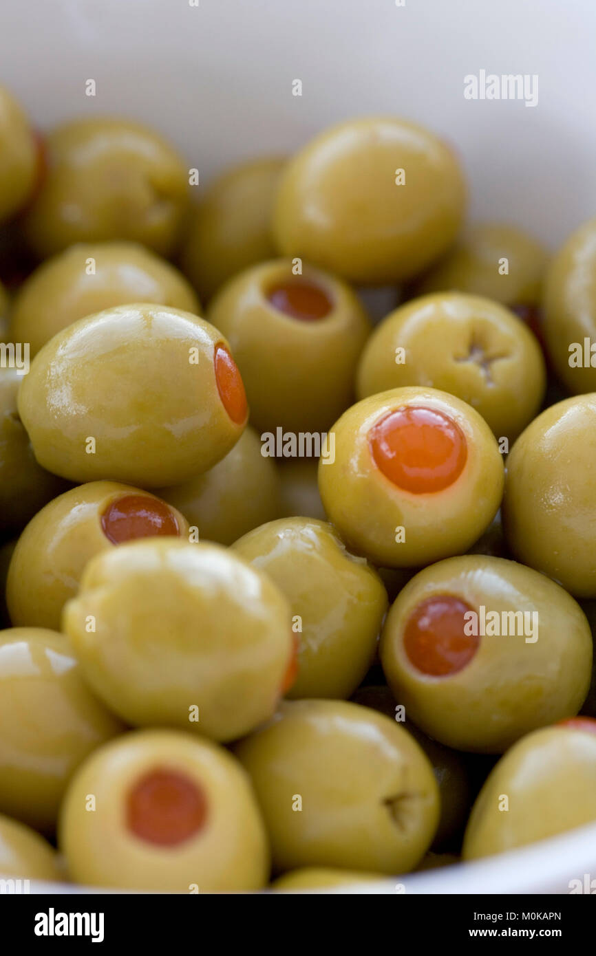 Pimento stuffed green olives in a white bowl Stock Photo - Alamy