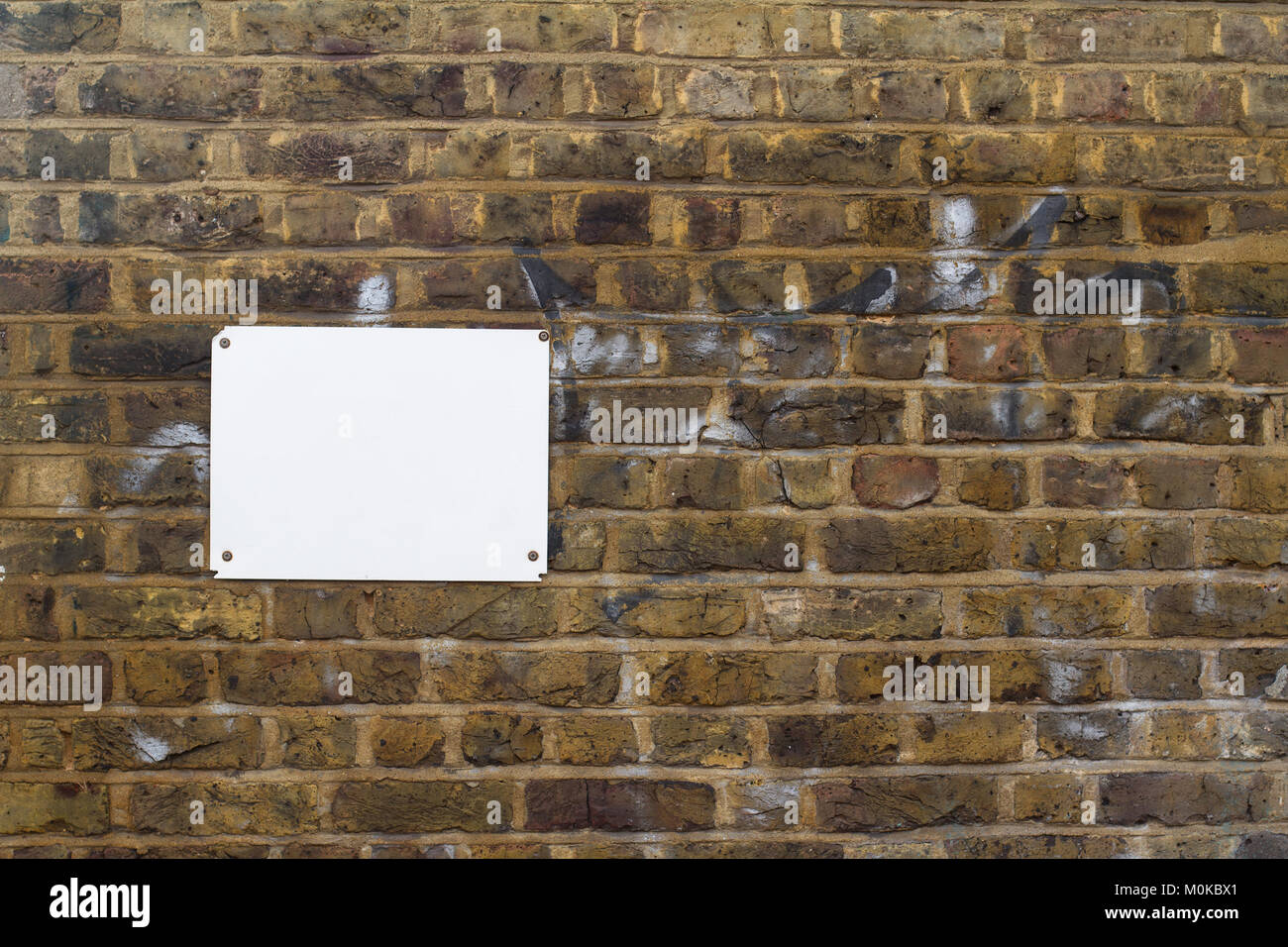 front view of white iron blank signage board on brick background Stock ...