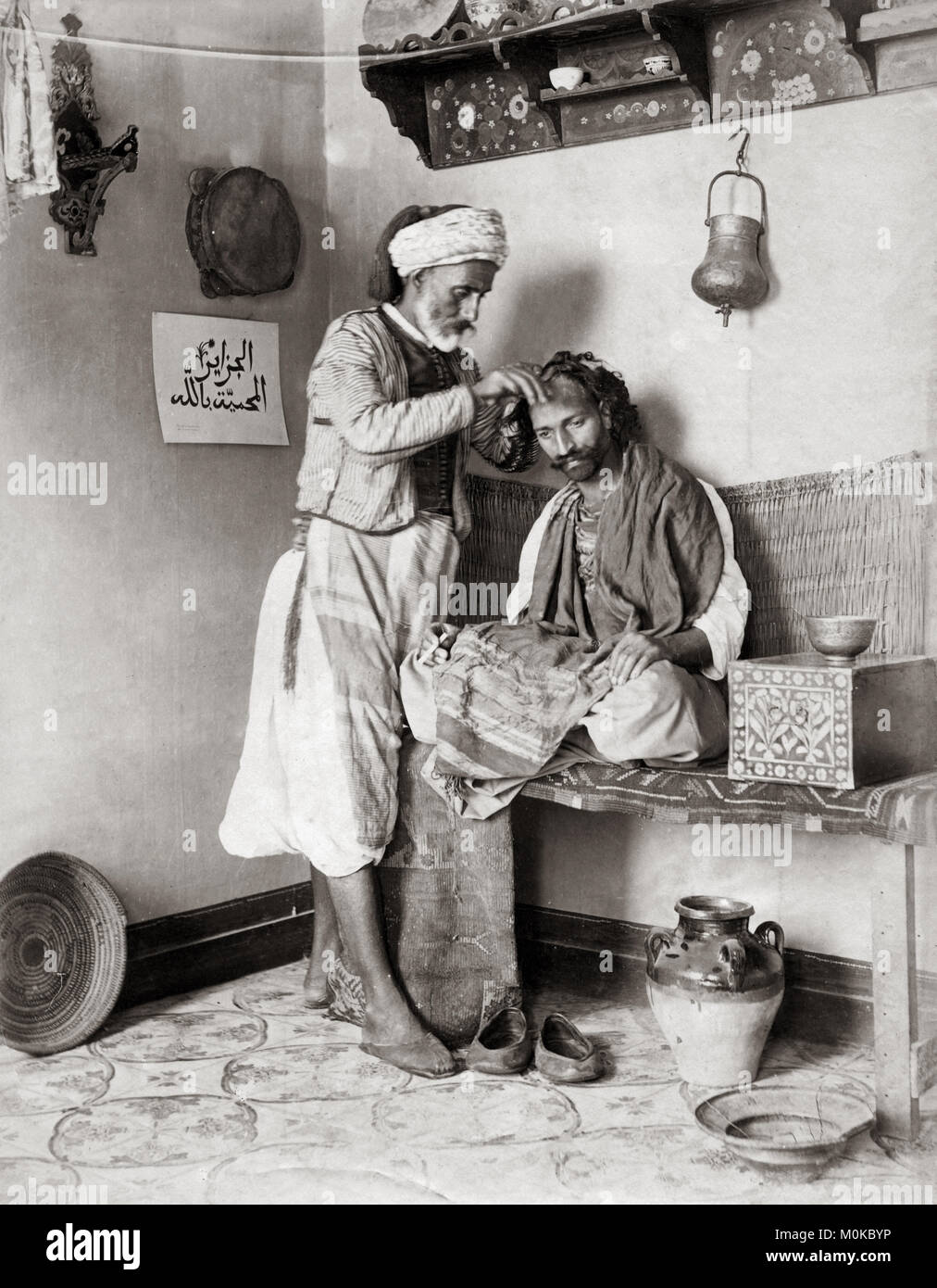 Barber at work, north Africa, c.1890 Stock Photo - Alamy
