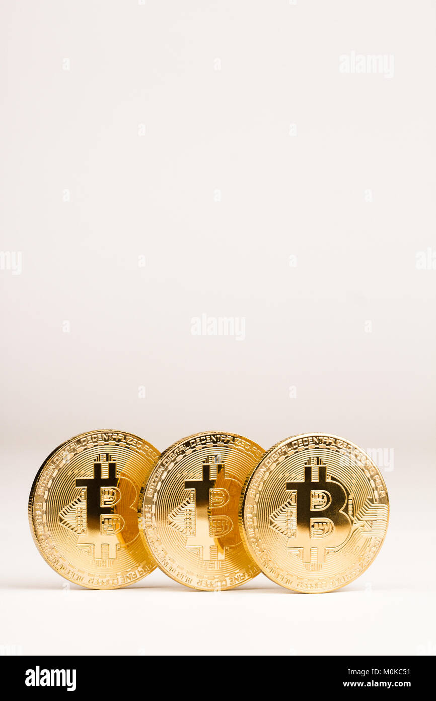 vertical front view closeup of bitcoin golden metallic coin on white ...