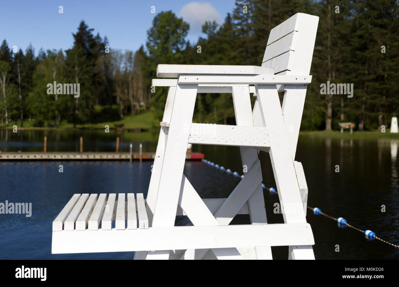 A white, wooden lifeguard chair at a lake at Lakeside Bible Camp ...