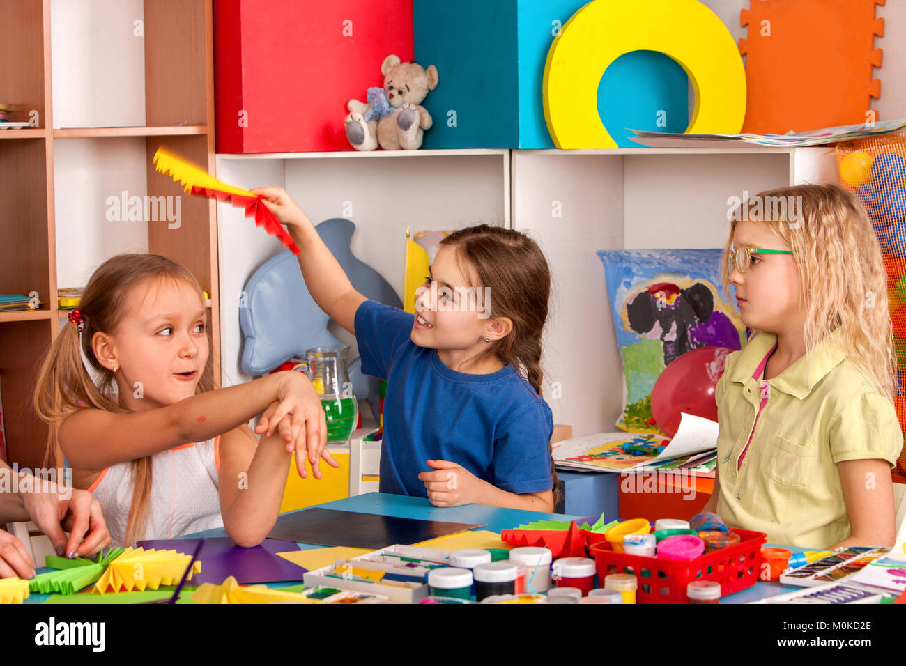 School children with scissors in kids hands cutting paper Stock Photo ...