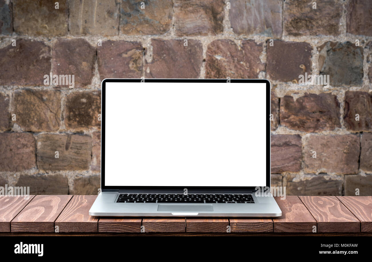 Modern laptop with empty white screen on wooden table against blurred ...