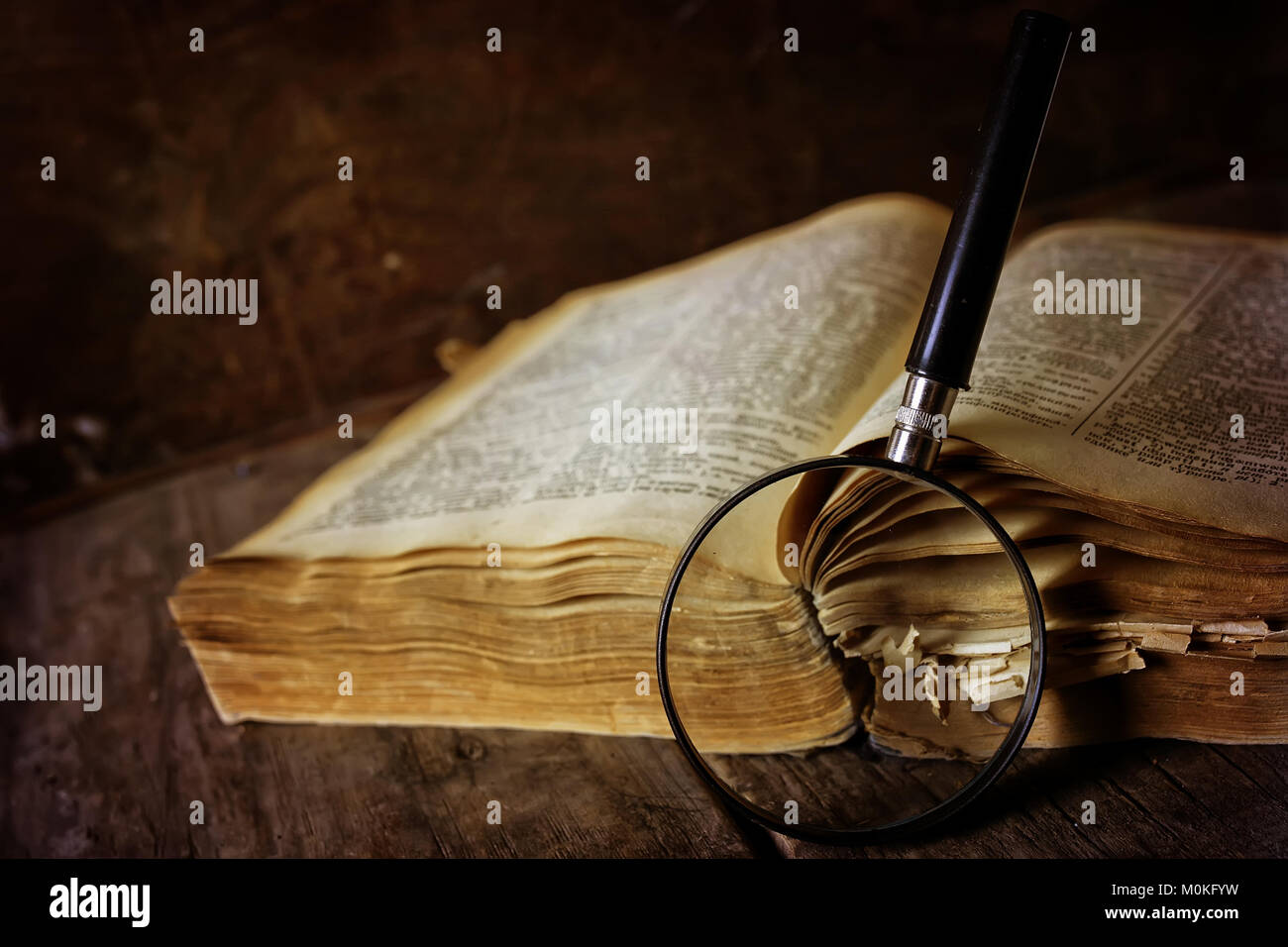 magnifying glass and old book Stock Photo - Alamy