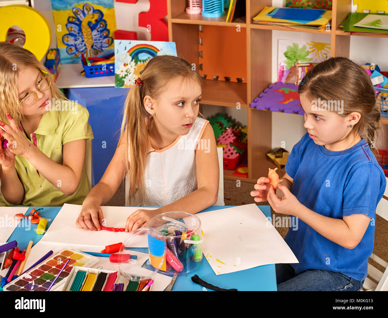 Plasticine modeling clay in children class. Teacher teaches in school ...