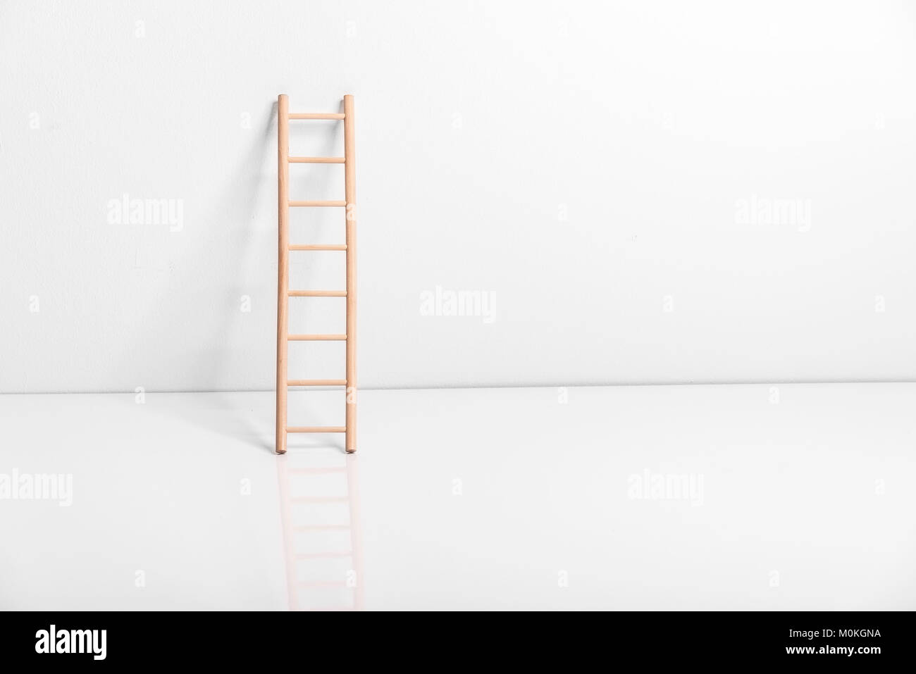 Wooden ladder leaning against the wall Stock Photo - Alamy