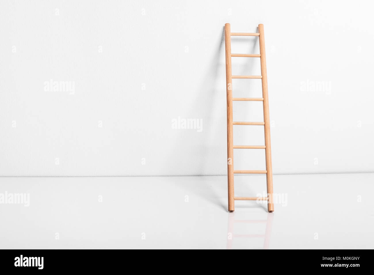 Wooden ladder leaning against the wall Stock Photo - Alamy