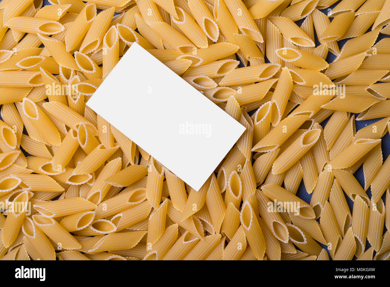 Blank business card on penne macaroni texture background. Top view ...