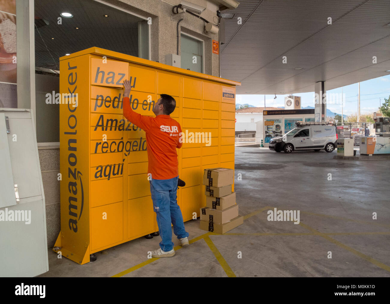 Logistics staff equips Amazon Locker with packages at gas station in ...