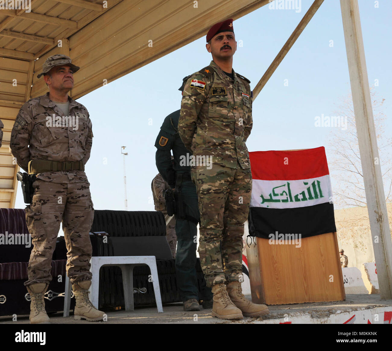 The Commander of Task Force Besmaya and an Iraqi officer congratulate ...