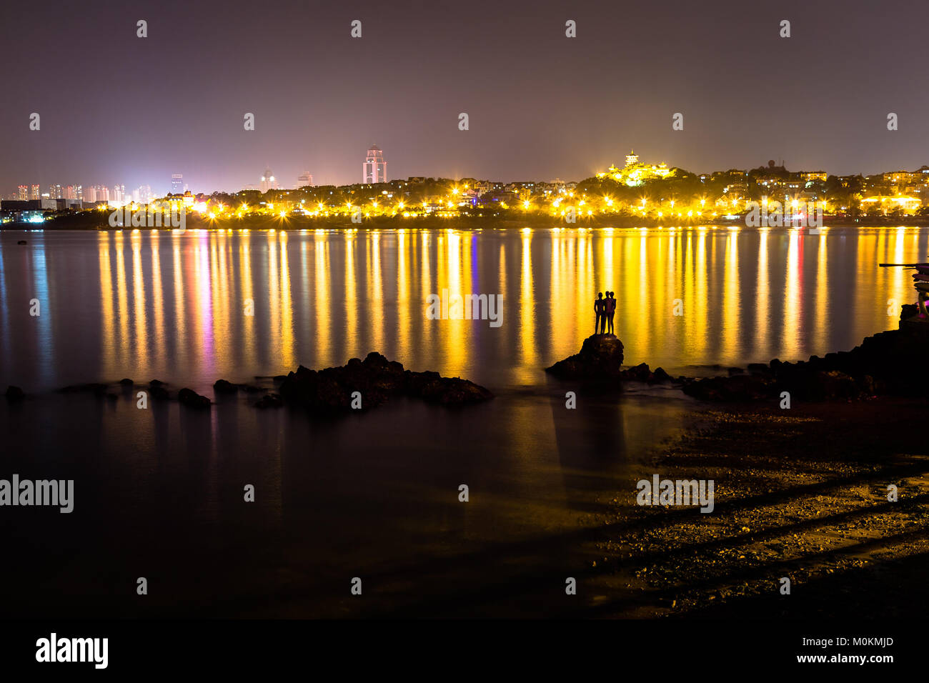 Three boys sculpture at night in Huiquan Bay, Yellow sea Shinan ...