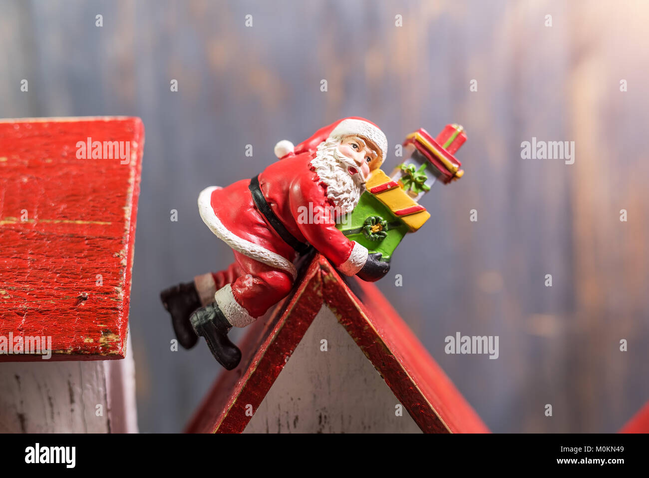 miniature figure Santa claus climb on roof chimney as christmas ...