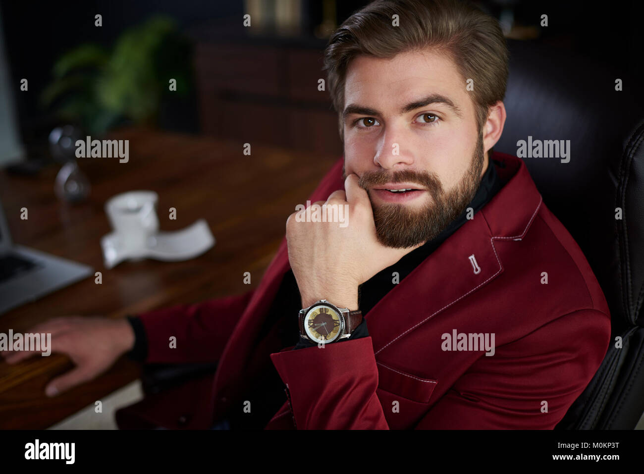 Portrait of businessman sitting at desk Stock Photo - Alamy