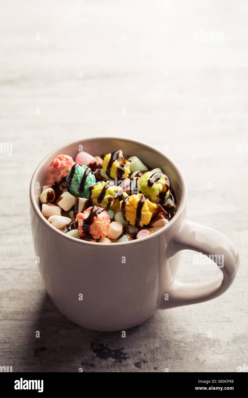 Cup of hot coffee with chocolate syrup, marshmallow and colorful ...