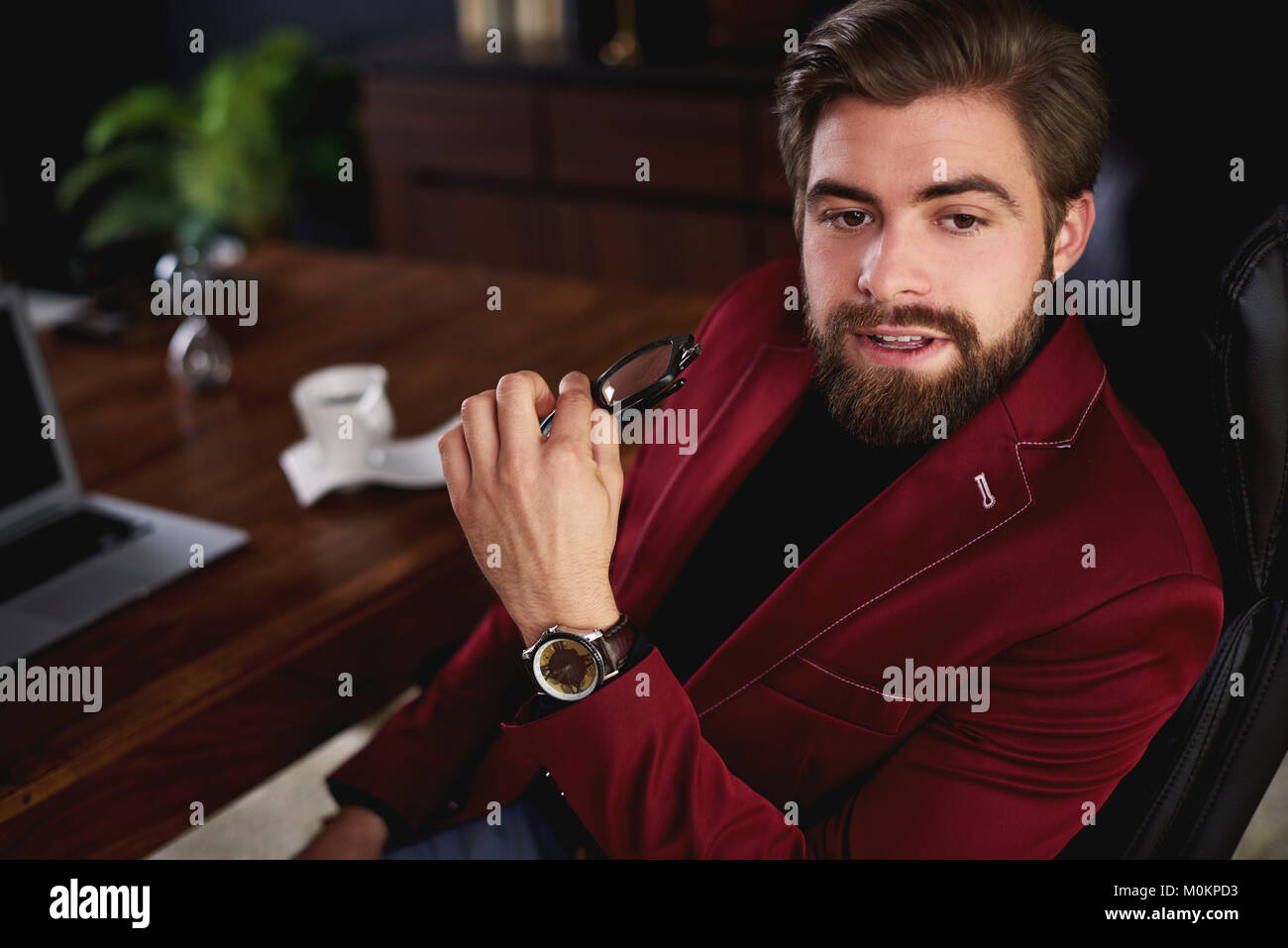 Business person sitting at his desk and resting Stock Photo - Alamy