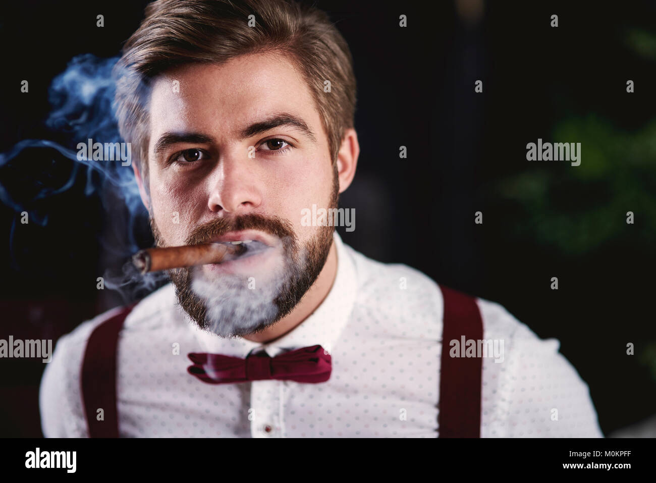 Front view of handsome man smoking cuban cigar Stock Photo - Alamy