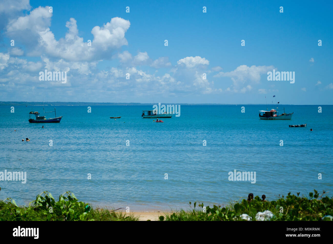 view of a beach with a calm sea and a very beautiful blue with 3 ...