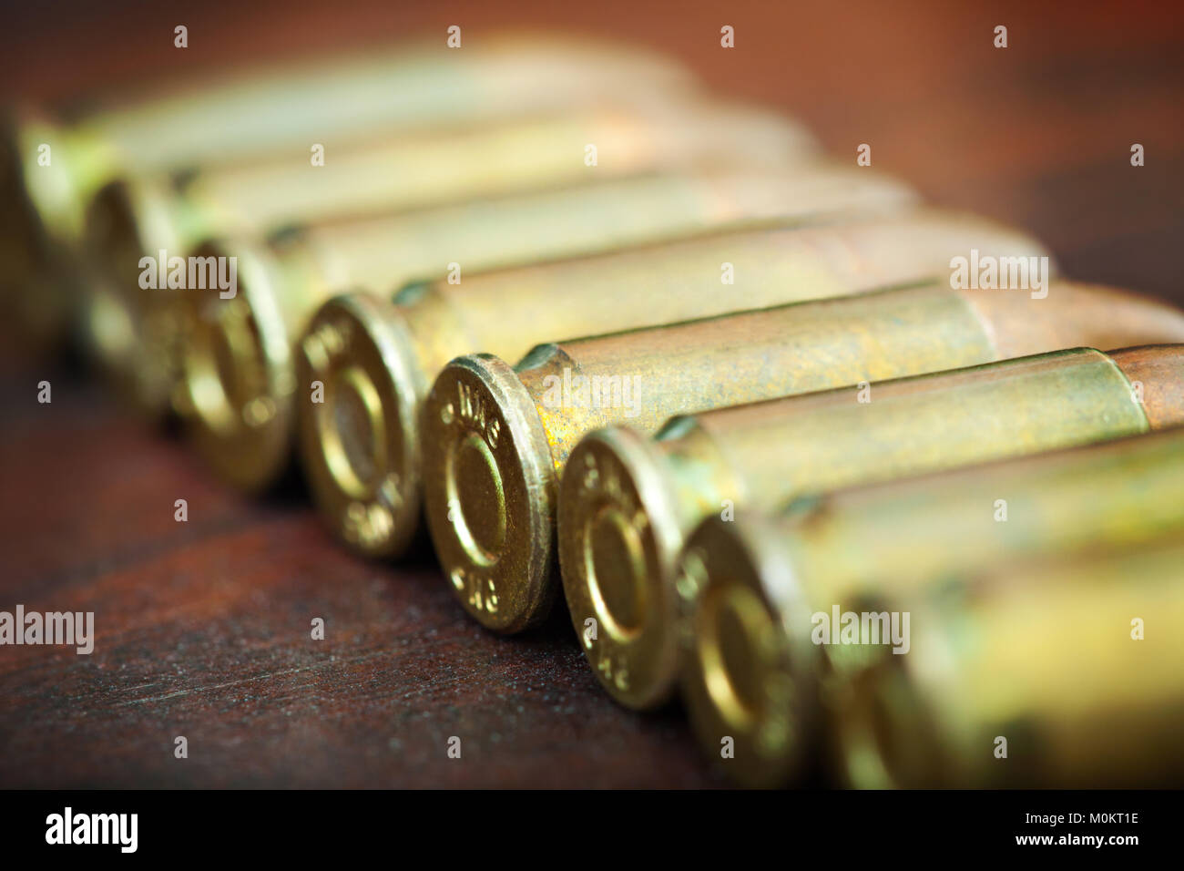 raw of bullets on the wooden table Stock Photo - Alamy